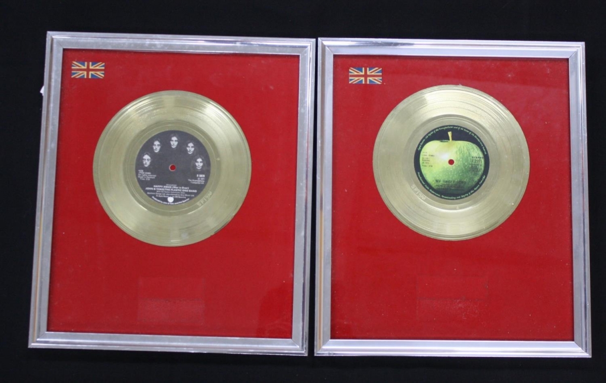 Two replica gold disc displays, framed and glazed with the flag of the ...